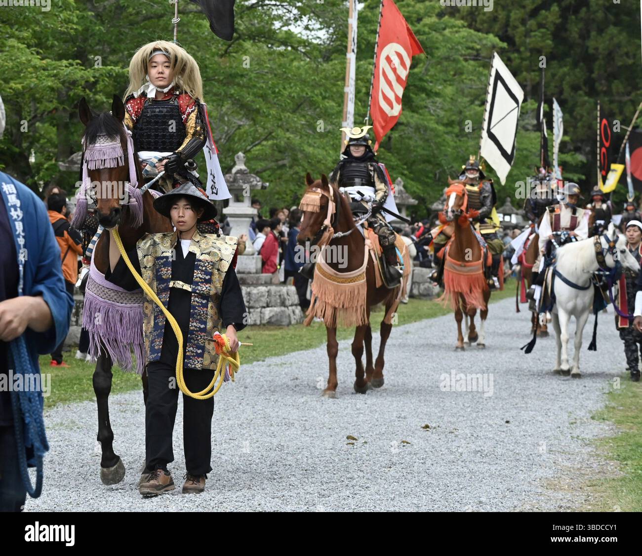 Samurai horseback riders clad in armor march along the front approach ...