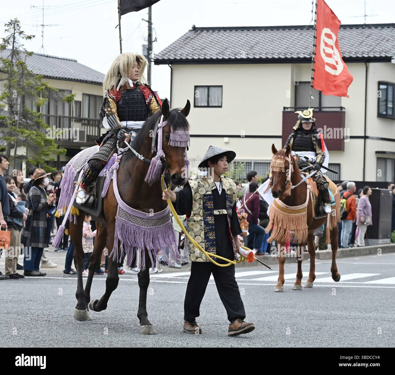 Samurai horseback riders clad in armor march along the front approach ...
