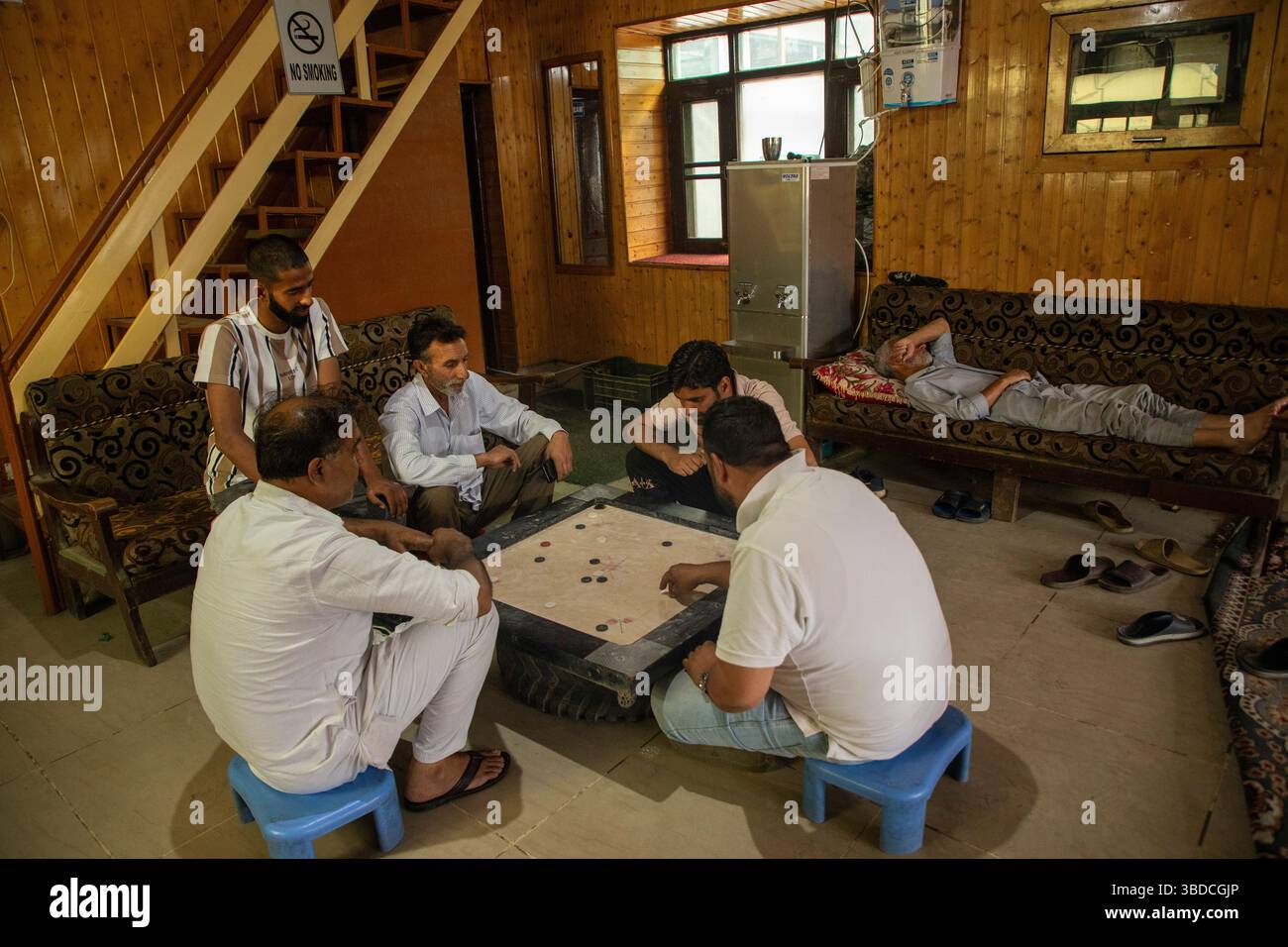 Kashmiri taxi drivers are seen playing carom inside their taxi stand ...