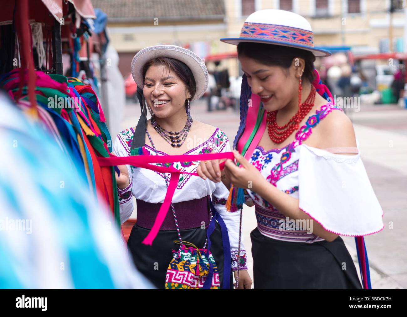Two smiling indigenous women wearing traditional andean clothing and ...