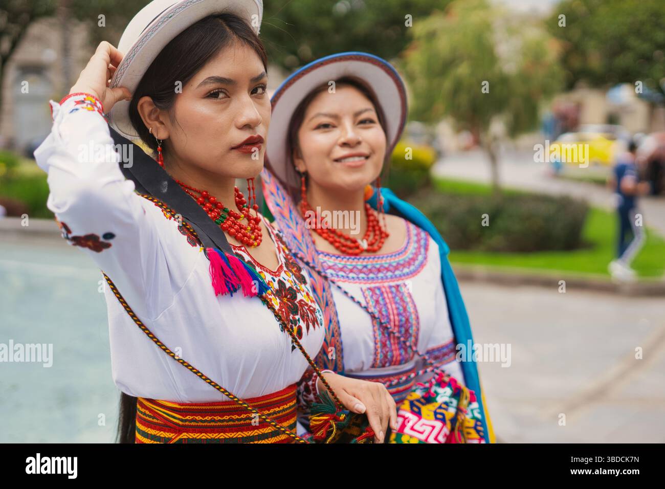 Two smiling indigenous otavalo women wearing traditional andean ...