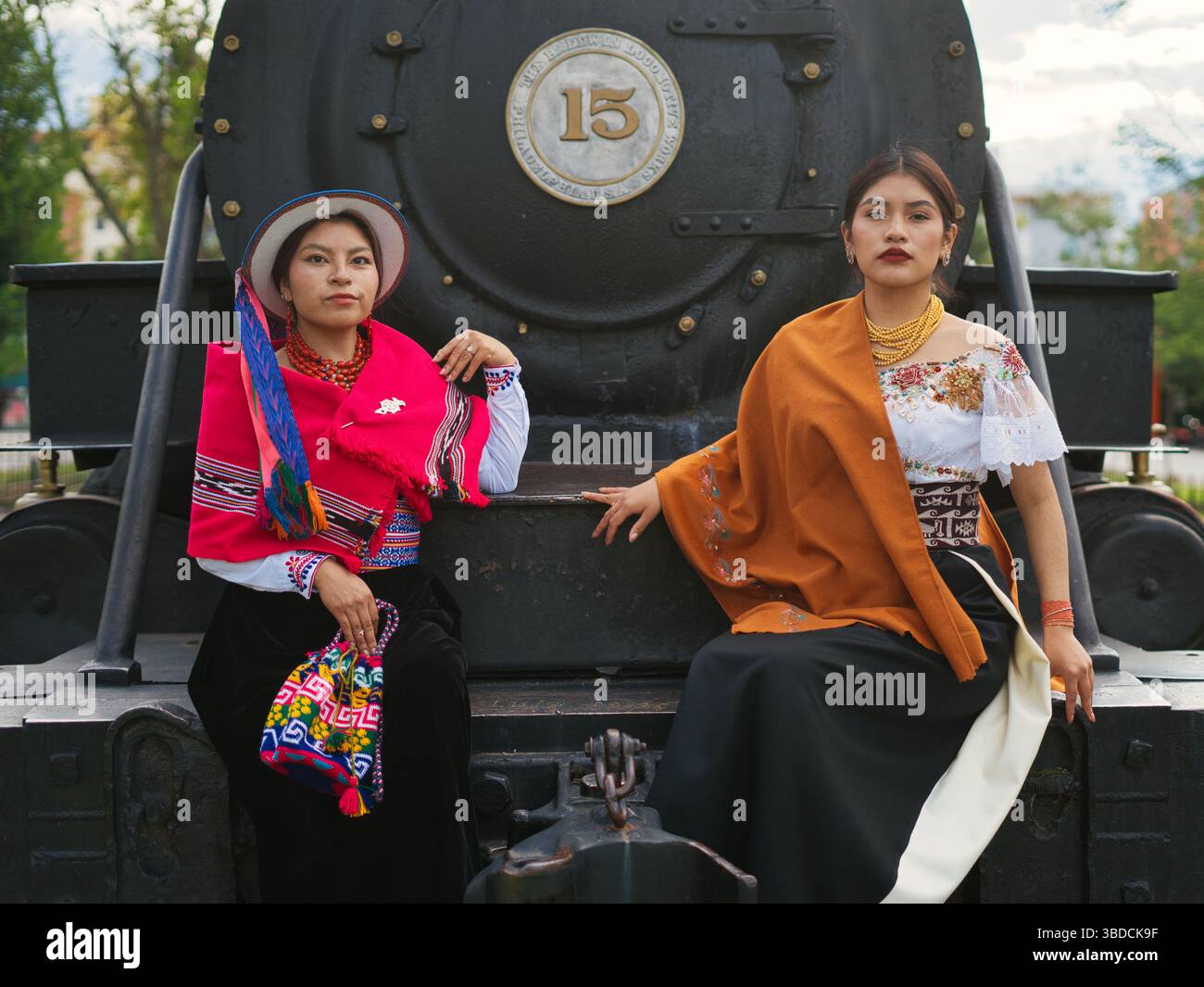 Two indigenous women wearing traditional, colorful clothing and ...