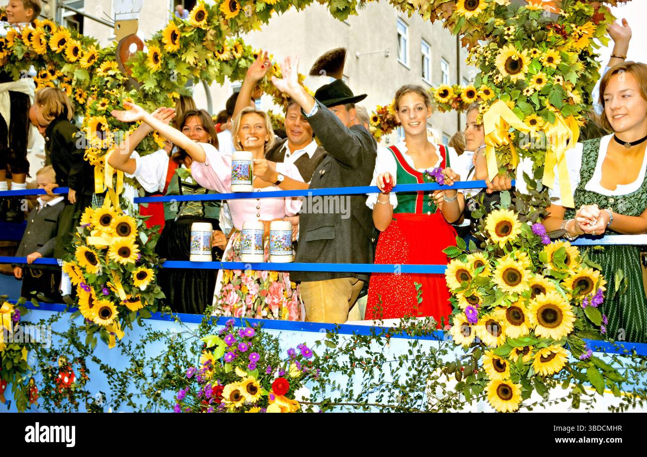 Happy people in traditional Bavarian costume on a float during the ...