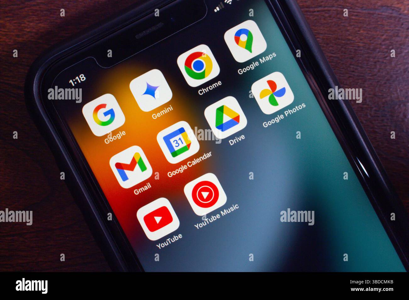 Angled view of a smartphone screen showcasing a grid of Google app ...
