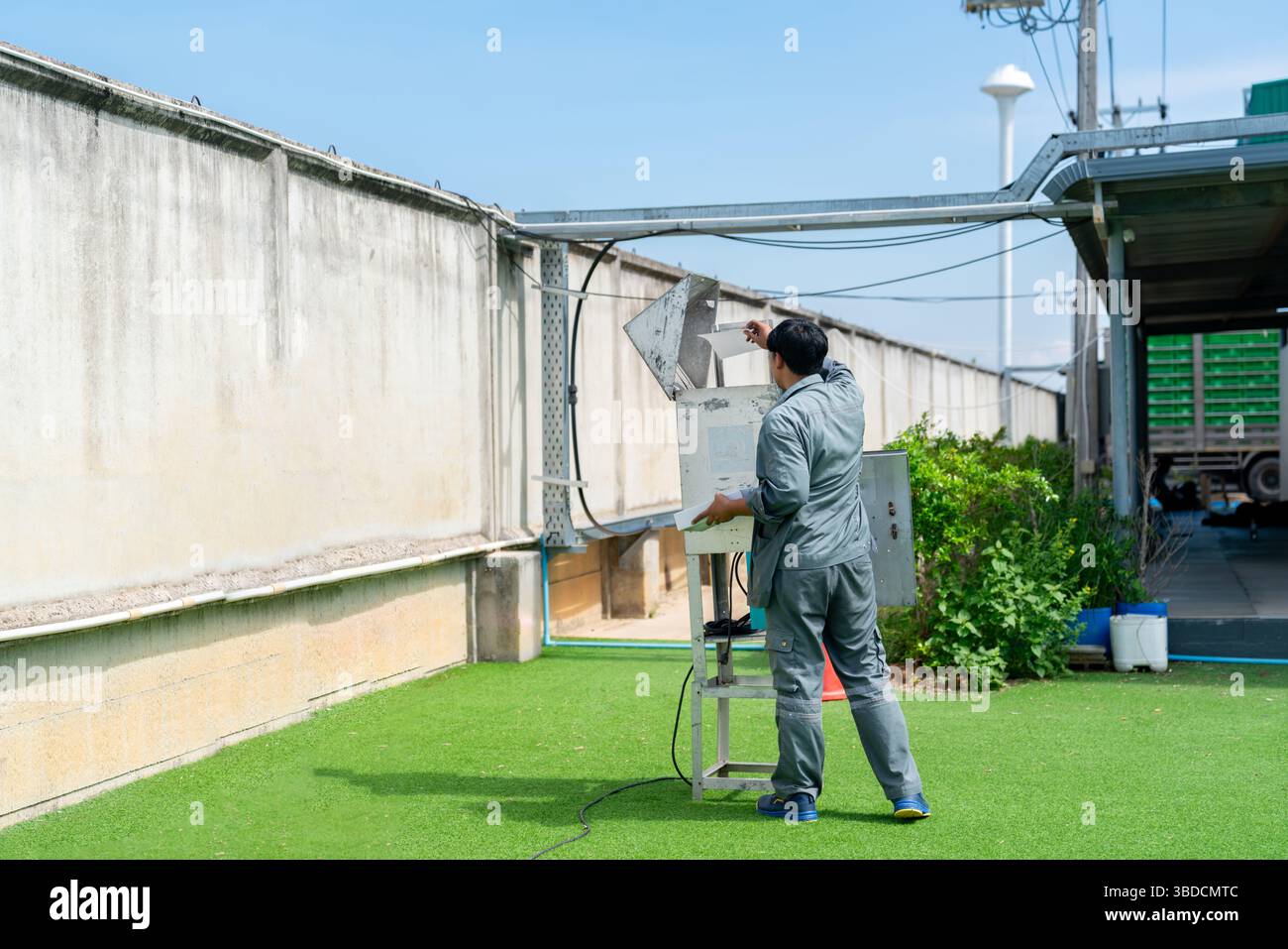 The environmental monitoring officer is installing a filter onto the ...