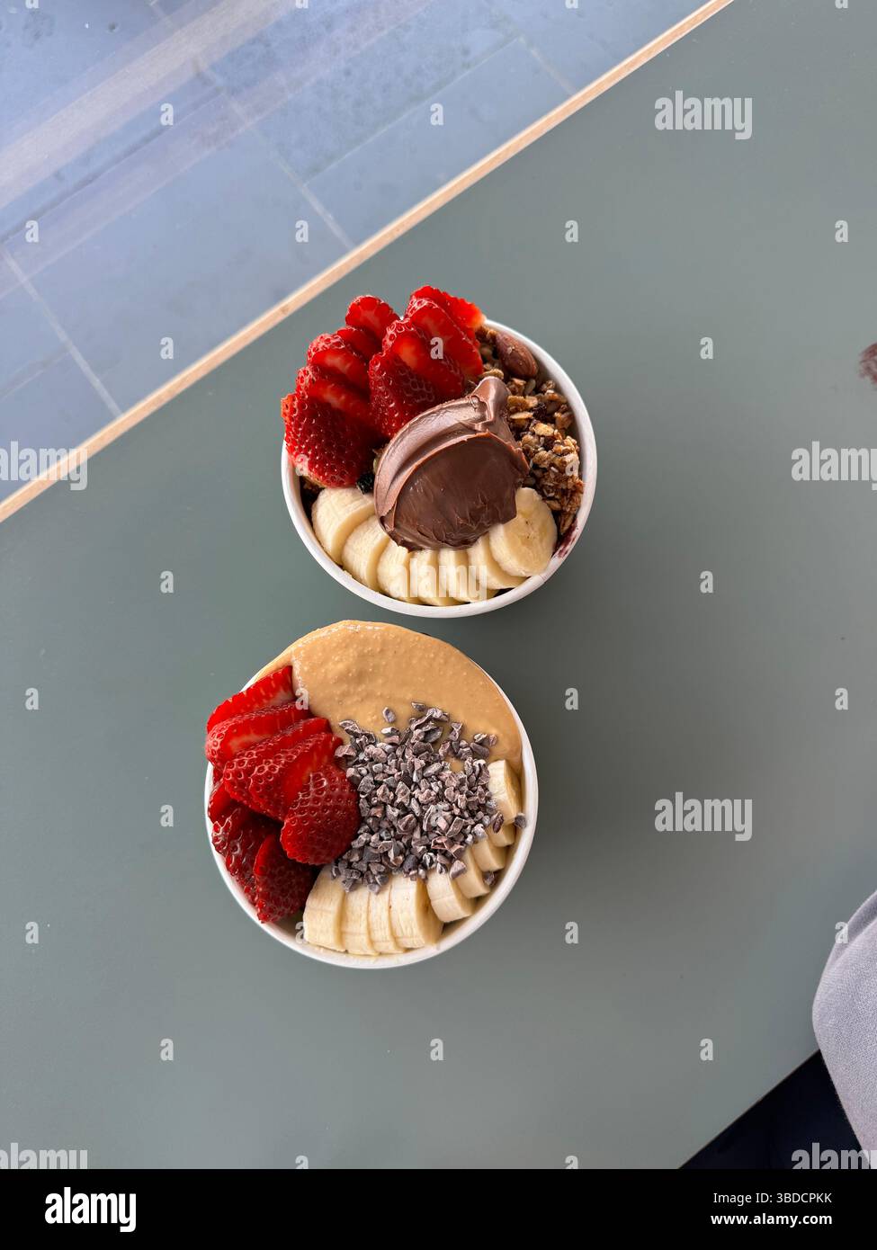 Birds eye view of two Acai Bowls sitting side by side on a table in an ...