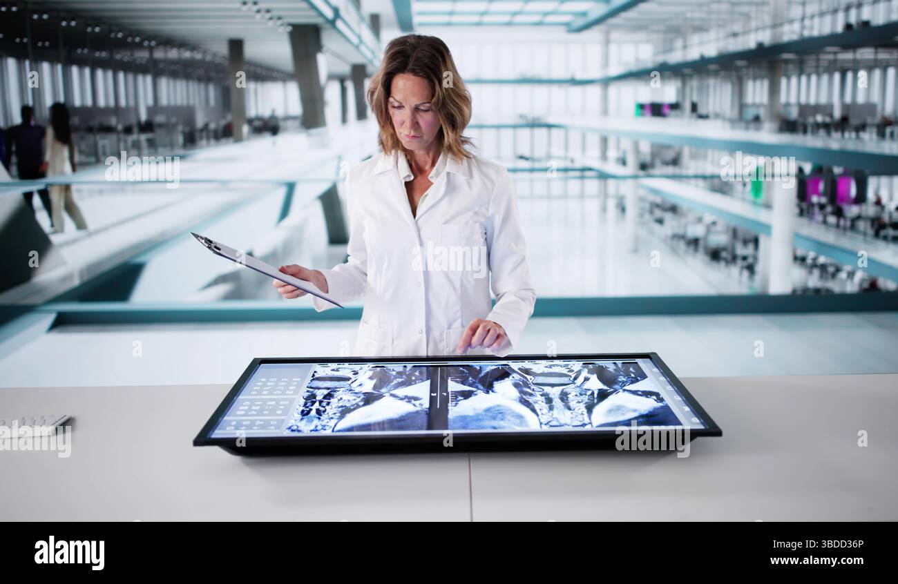 Female Radiologist Using Computer To Analyze MRI Scans In Hospital ...