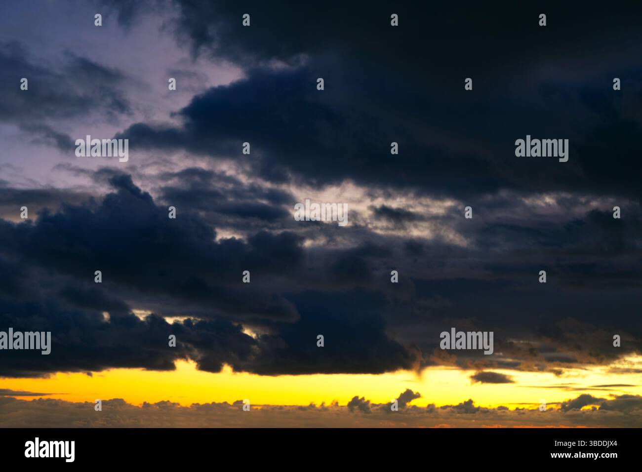 Dramatic sky with dark storm clouds blocking light from rising sun ...