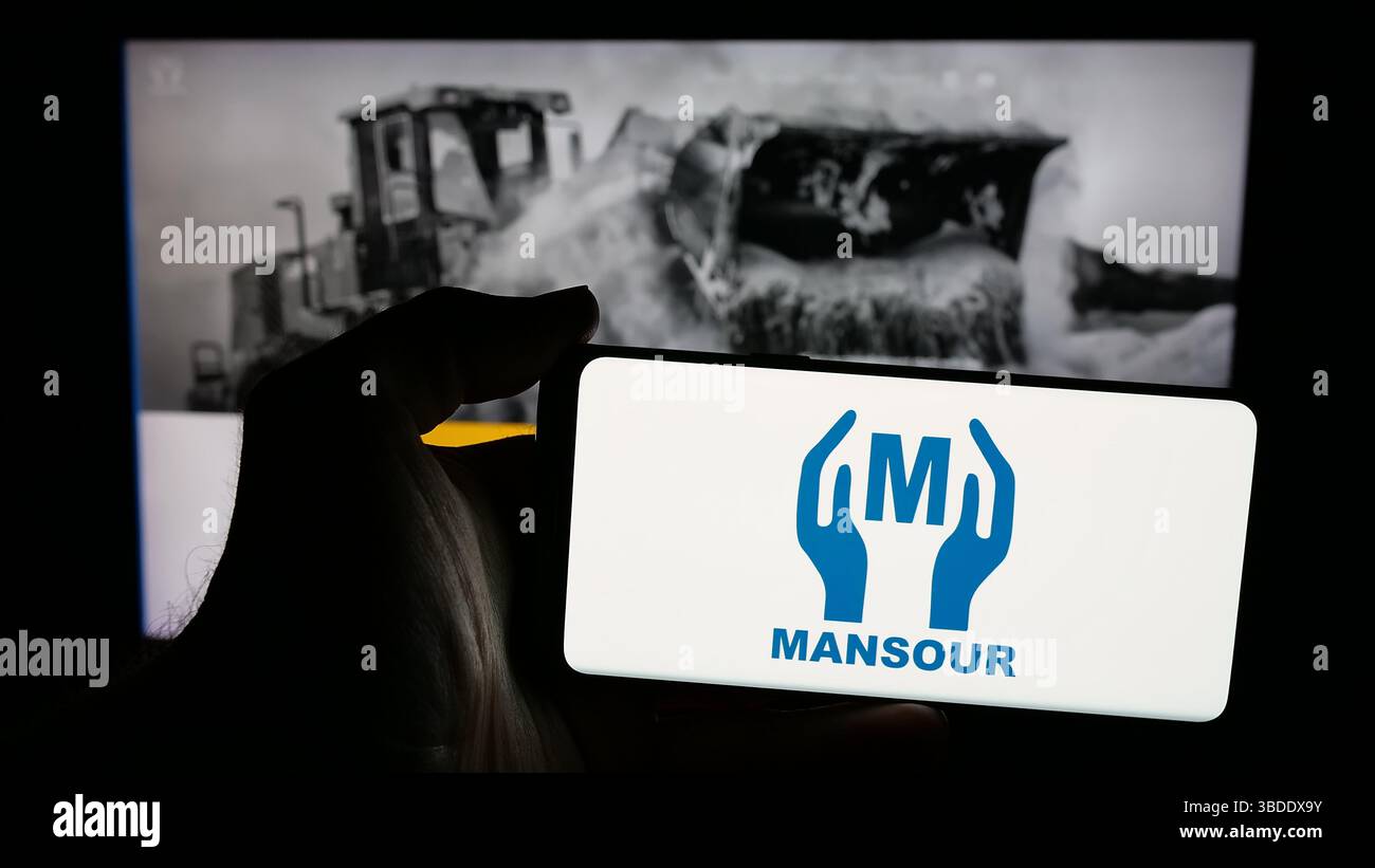 In this photo illustration, a person is holding a mobile phone with the logo of Egyptian company ...