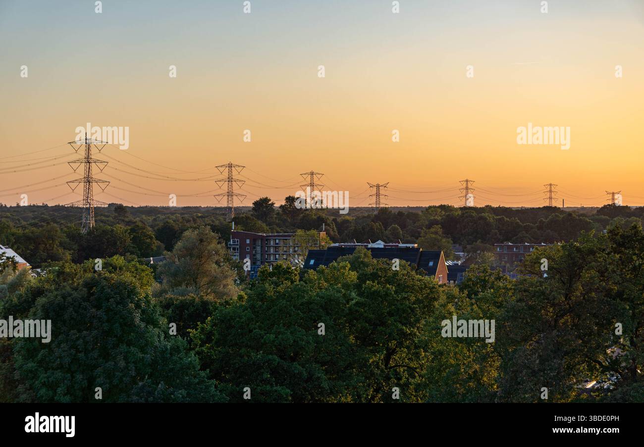 landscape at sunset, with several high-voltage power transmission ...