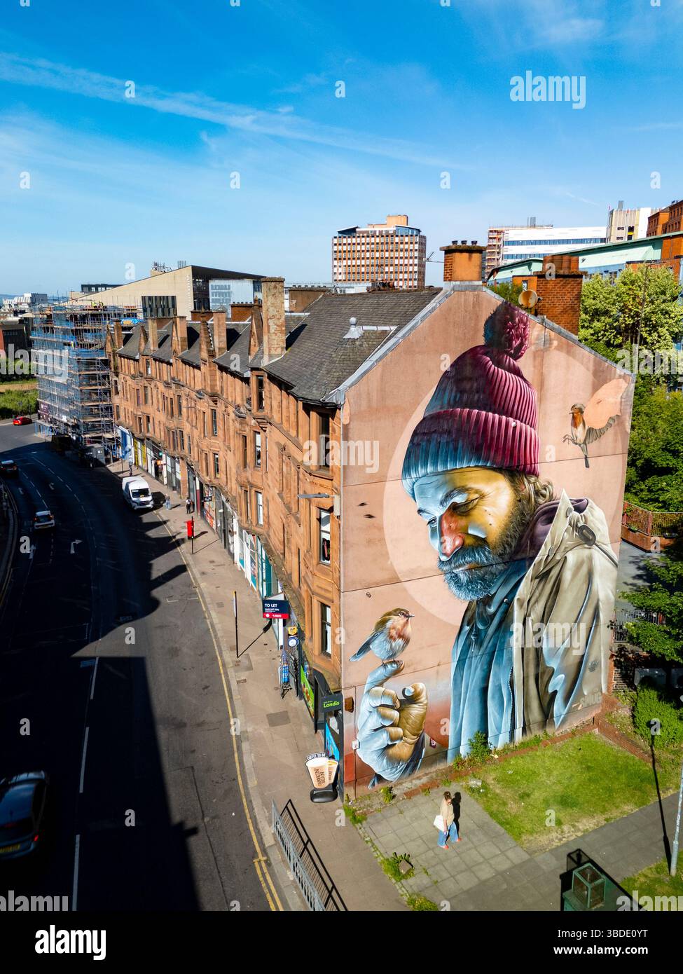 Mural on tenement building by street artist Smug, depicts a modern-day ...