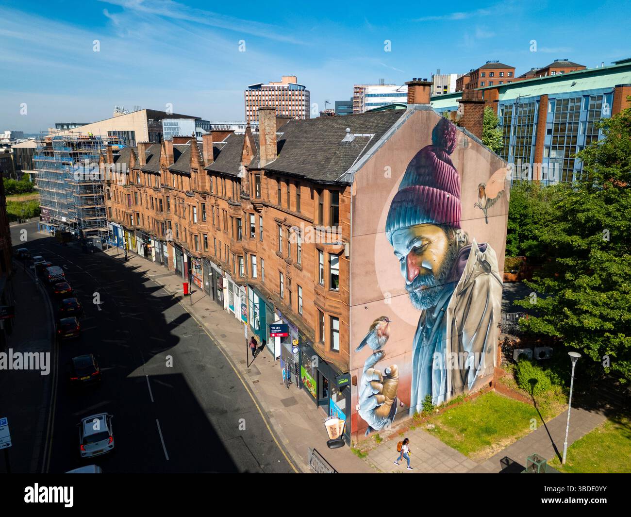 Mural on tenement building by street artist Smug, depicts a modern-day ...
