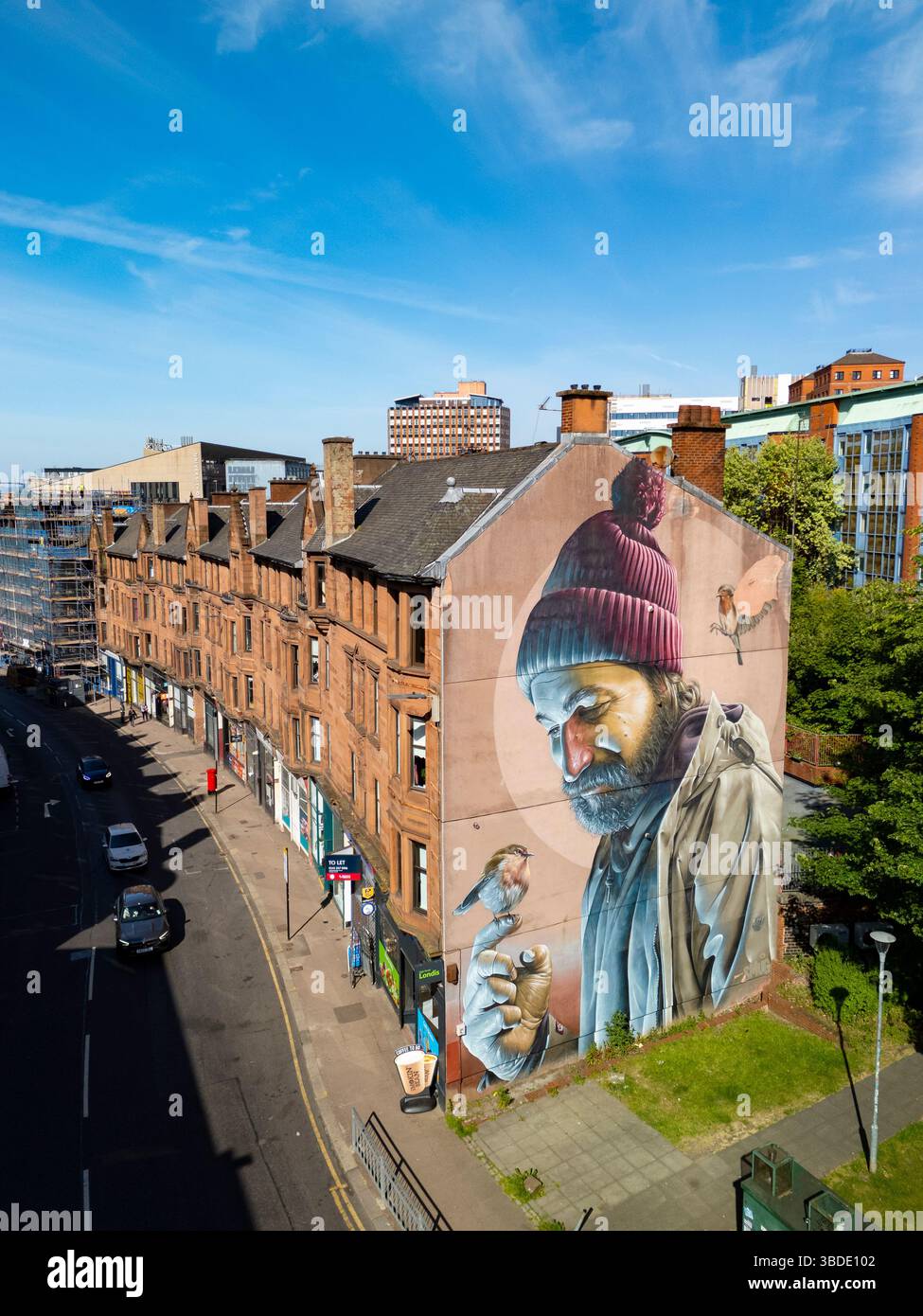 Mural on tenement building by street artist Smug, depicts a modern-day ...