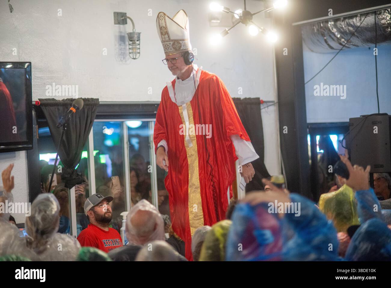 Preston Elliot dressed as the Pope, gives the annual “Blessing of Beer ...
