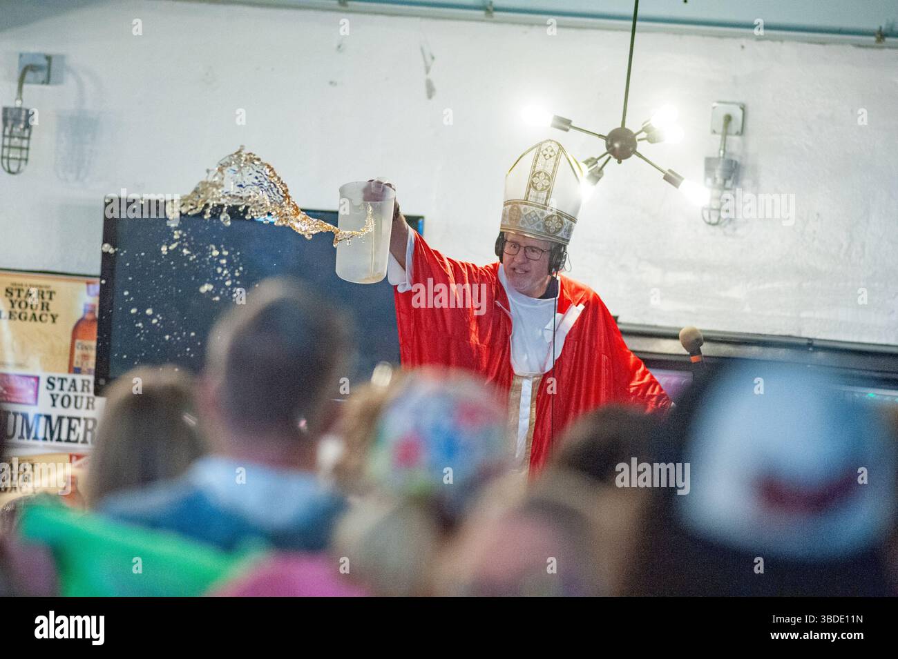 Preston Elliot dressed as the Pope, gives the annual “Blessing of Beer ...