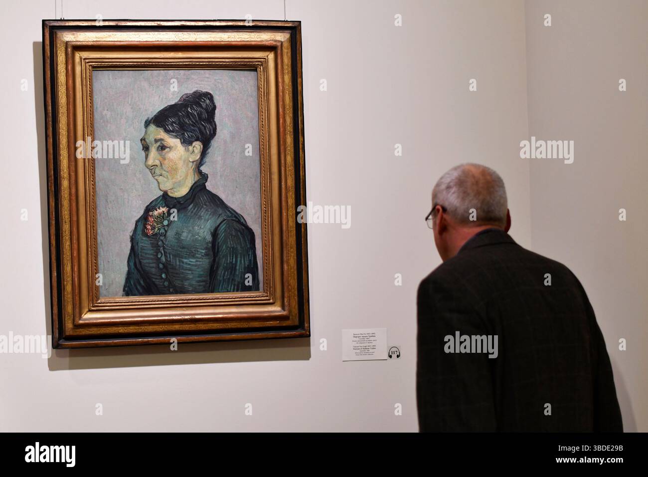 Visitor looking at the painting by Vincent Van Gogh Madame Trabuc,State ...