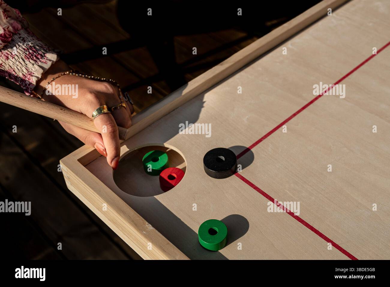 Novuss game with female hand holding a cue, Denmark, March 26, 2025 ...