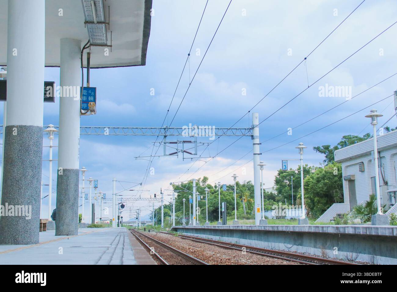 Taiwan May 21, 2024: A railway track curving into the distance beside a ...