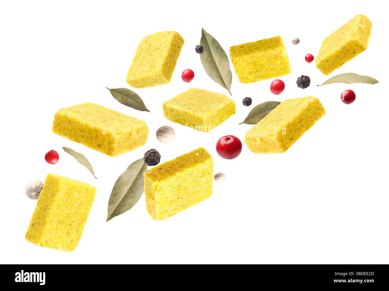Bouillon cubes and spices flying on white background Stock Photo - Alamy