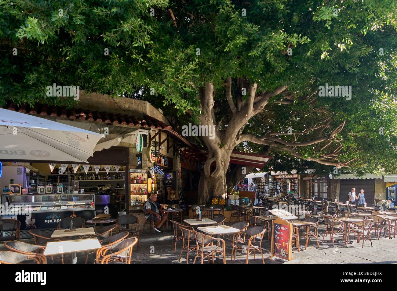 Rhodes.Greece May 24, 2025: An inviting outdoor cafe scene with tables ...
