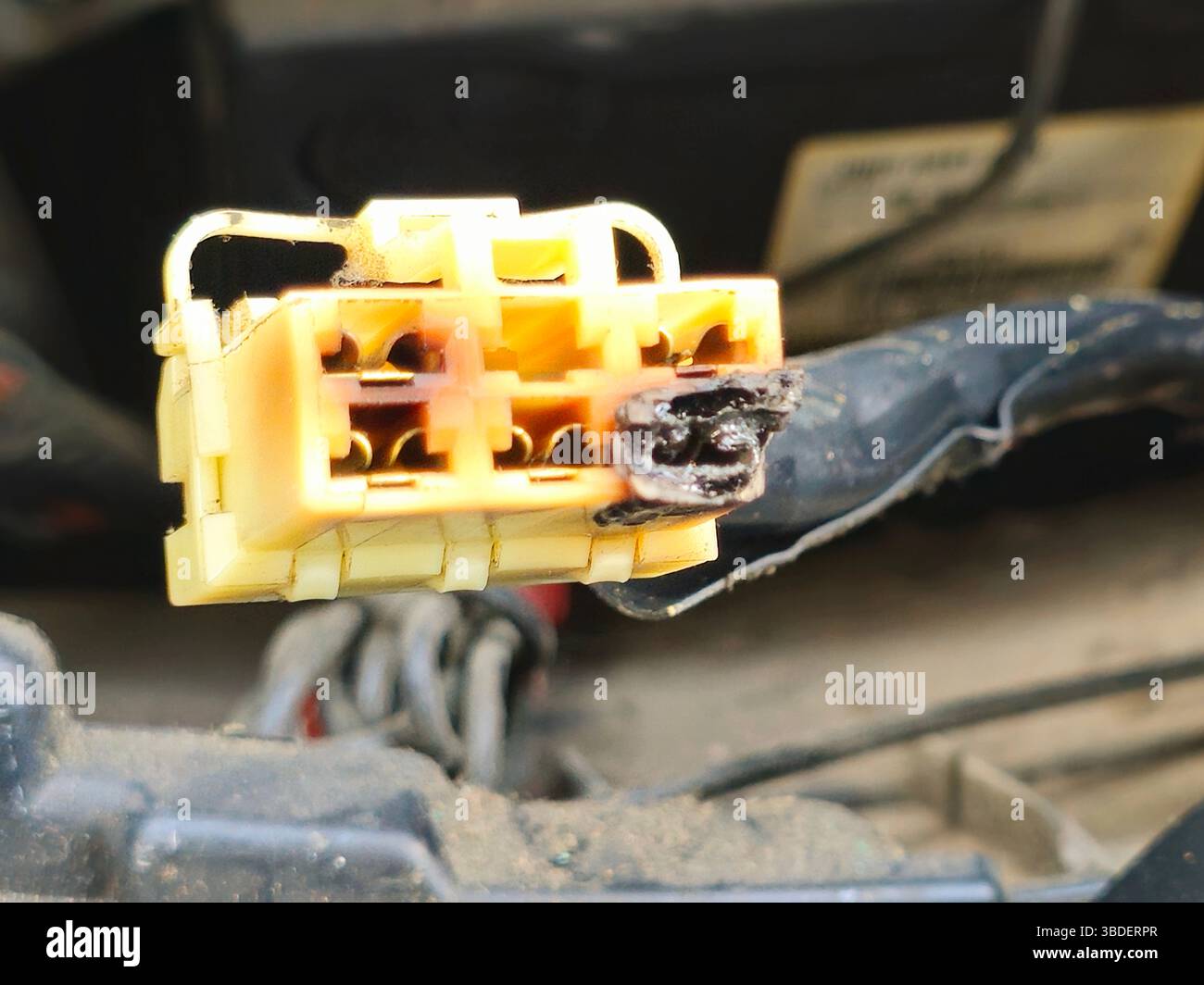 A burnt plug in the car electricity system connected to the wires that ...