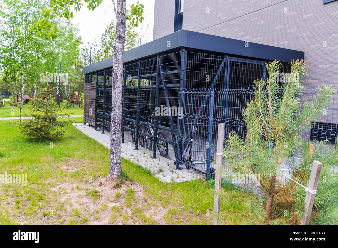 Bicycle storage called bike box next to the building Stock Photo - Alamy