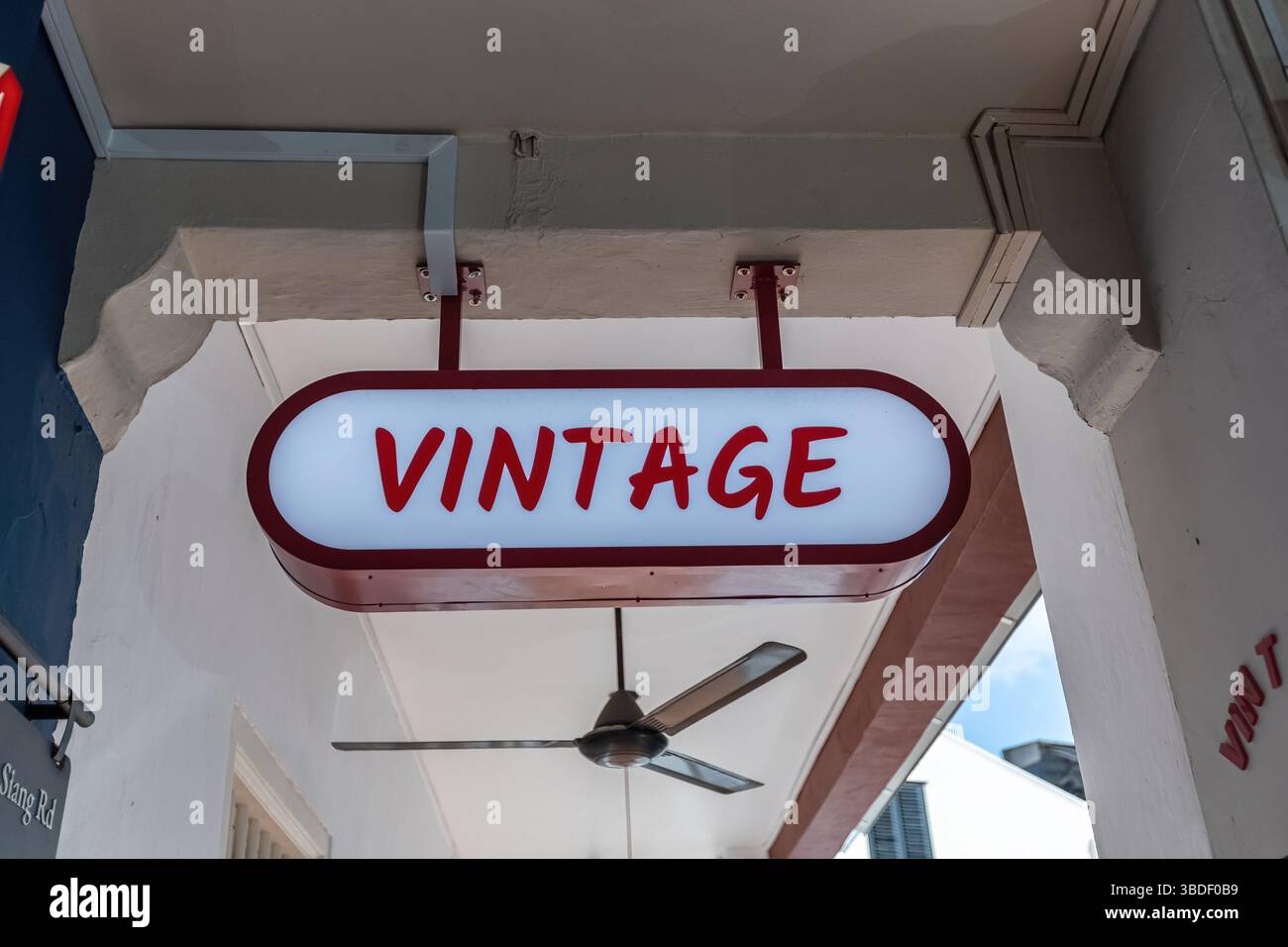 Neon sign board saying Vintage on the arch way of the street Stock ...