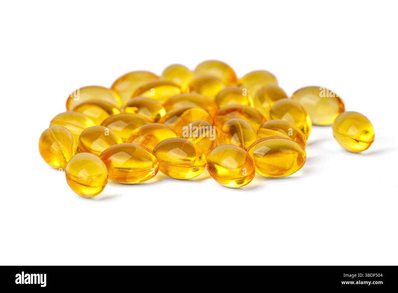 Pile of yellow vitamin D softgel capsules on white background Stock ...