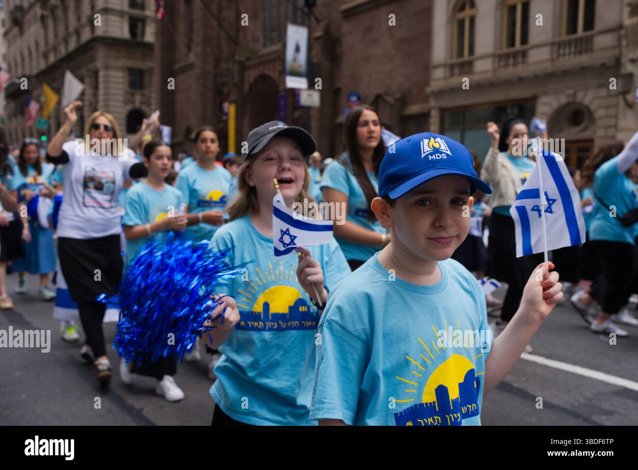 A vibrant street scene captures a group of children and adults ...