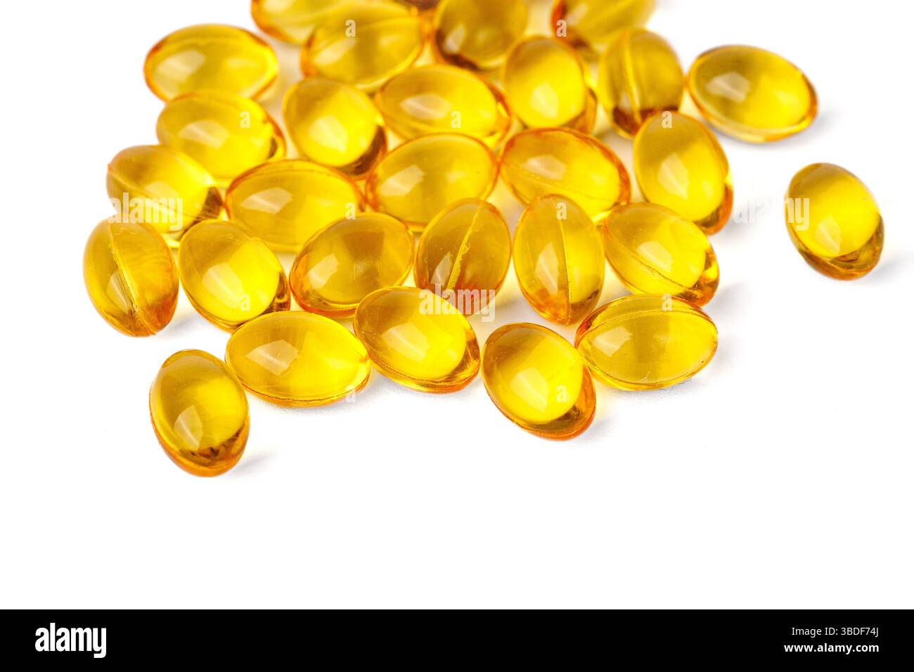 Pile of yellow vitamin D softgel capsules on white background Stock ...