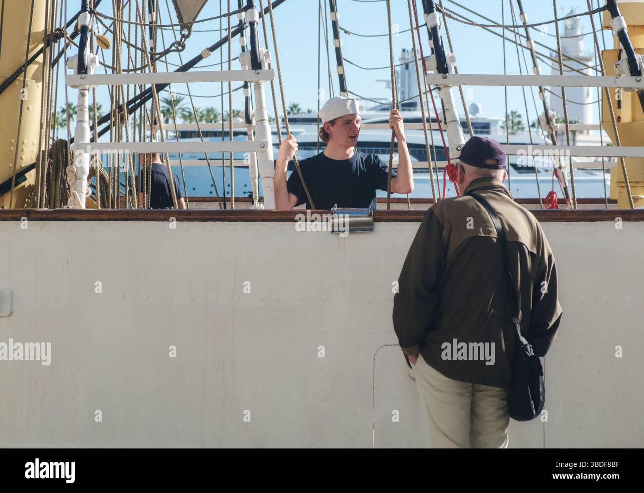 Two friends engage in deep conversation on a sunny ship deck amidst ...