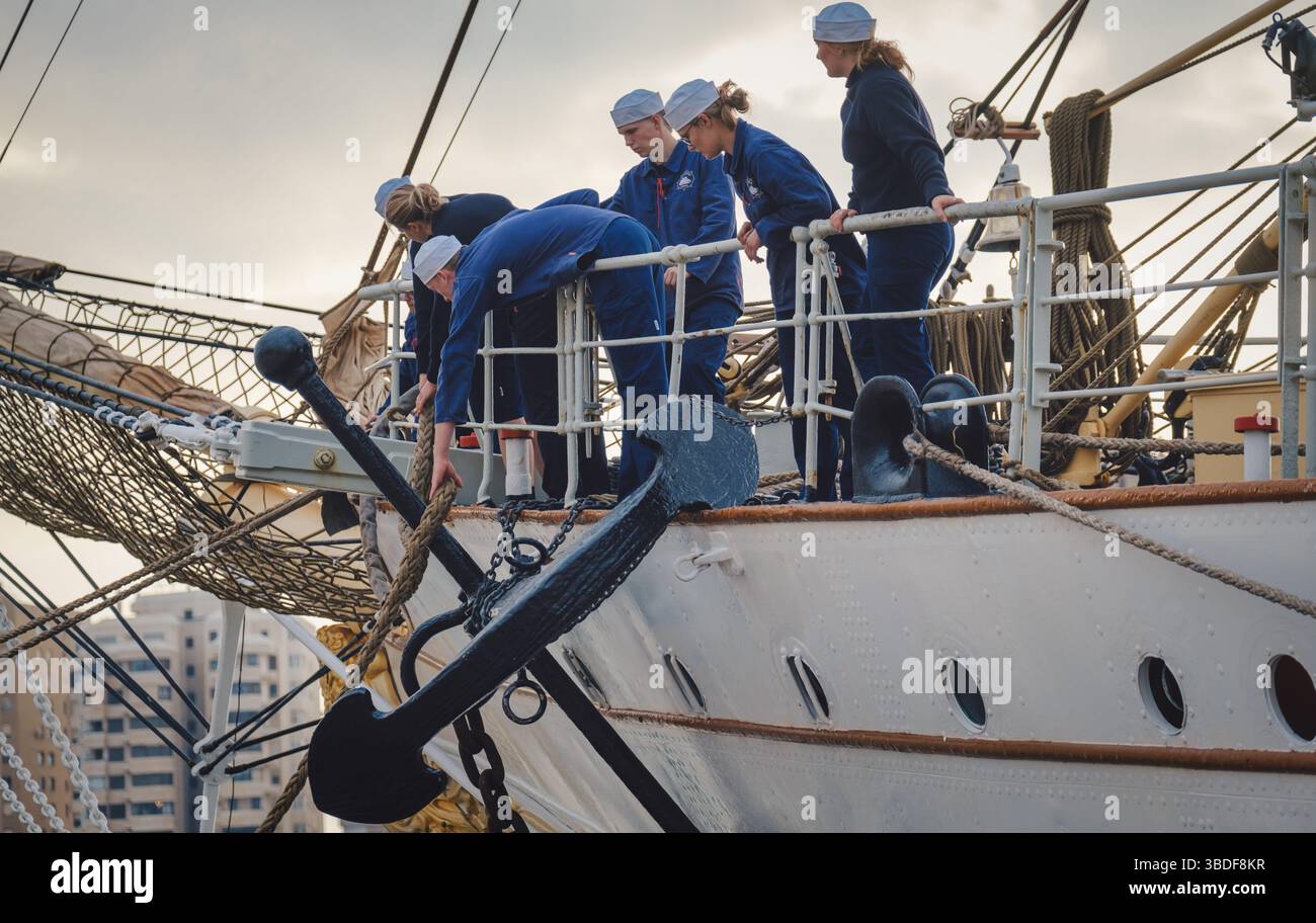 Spain Malaga 1 28 2024 Sailors in blue uniforms gearing up for sea ...
