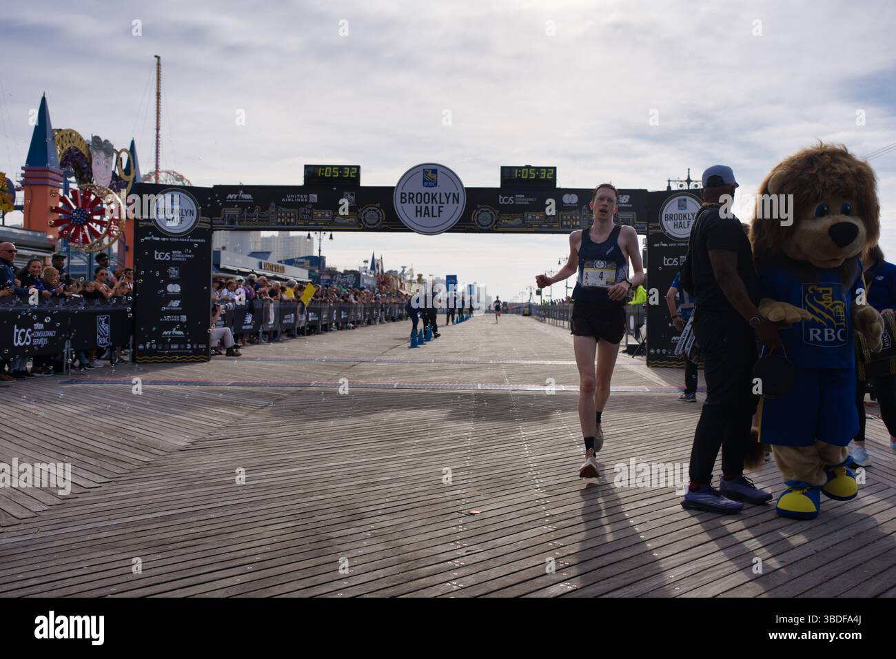 A male runner nears the finish line of the Brooklyn Half Marathon on a ...
