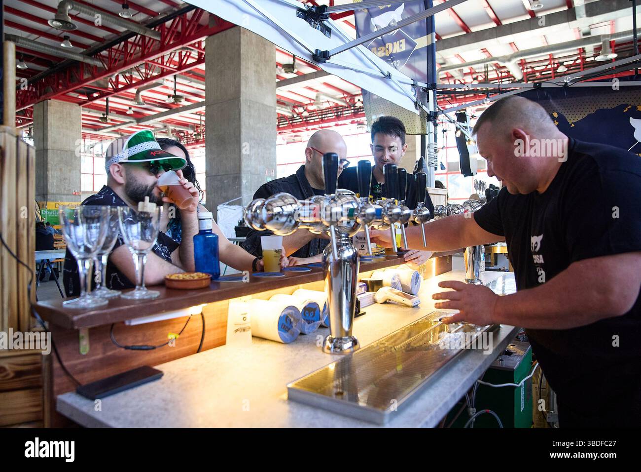 A waiter serves beer at the BeerMad 2025 beer festival, at the Pabellón ...