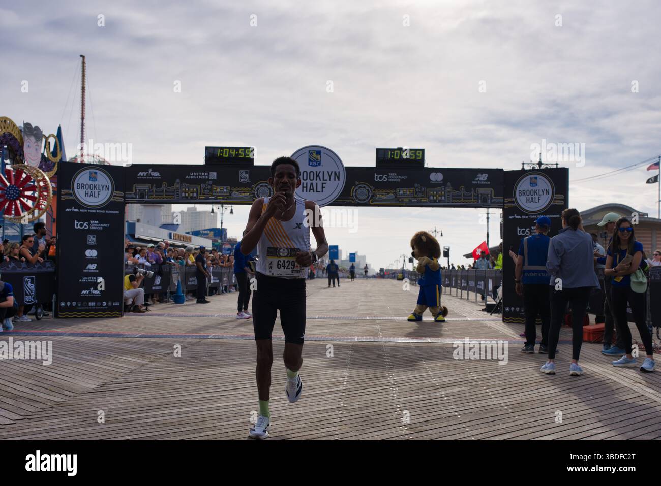 A male runner, bib number 6429, nears the finish line of the Brooklyn ...