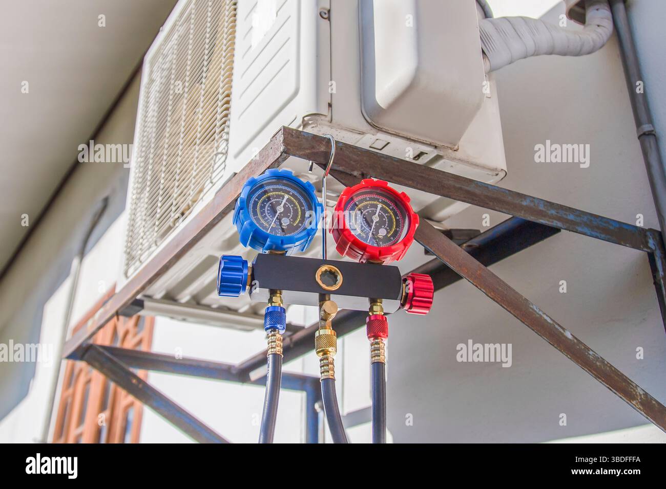 Air conditioning, HVAC service technician using gauges to check ...