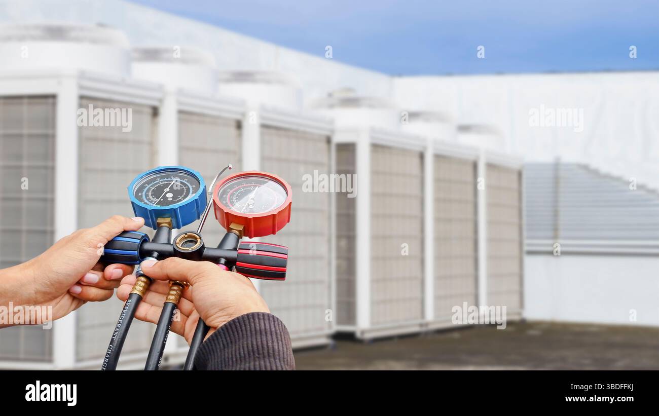 Air conditioning, HVAC service technician using gauges to check ...