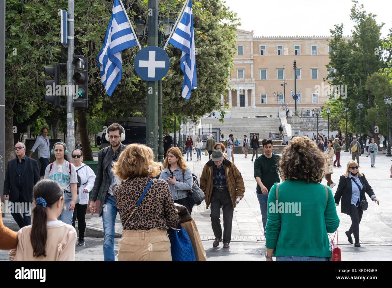 A small crowd of Greek commuters at a busy pedestrian crossing near ...
