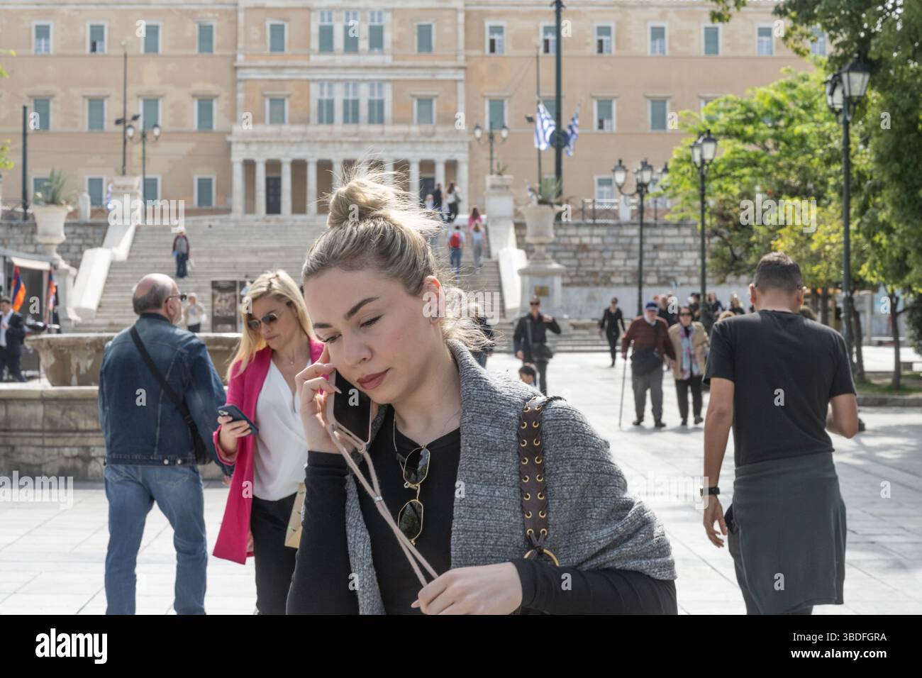 Greek commuters exit and enter the Syntagma Metro Station using mobile ...