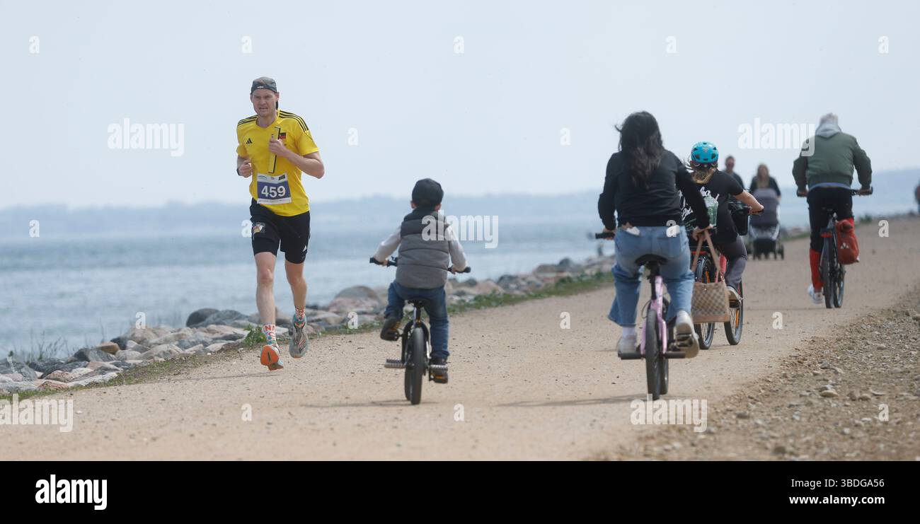 Damp, Germany. 24th May, 2025. A relay runner takes part in the 18th ...