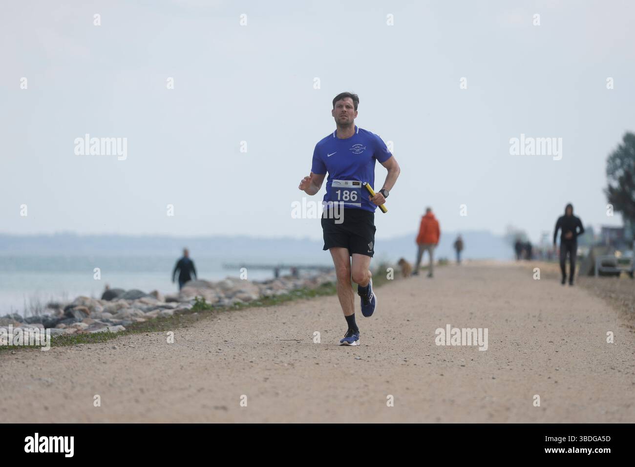 Damp, Germany. 24th May, 2025. A relay runner takes part in the 18th ...