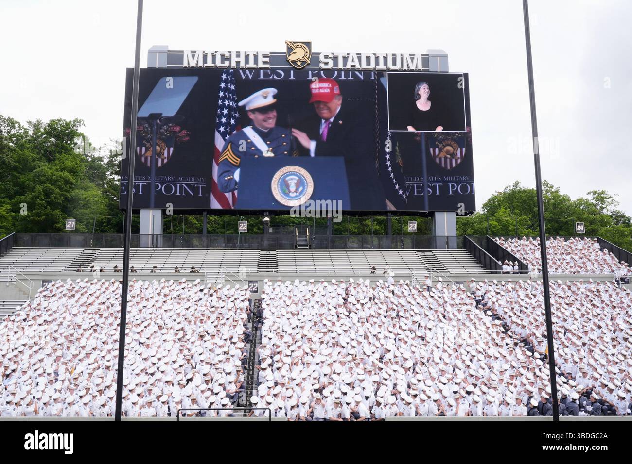 Graduating cadet Chris Verdugo, left, is pictured on screen alongside President Donald Trump as ...