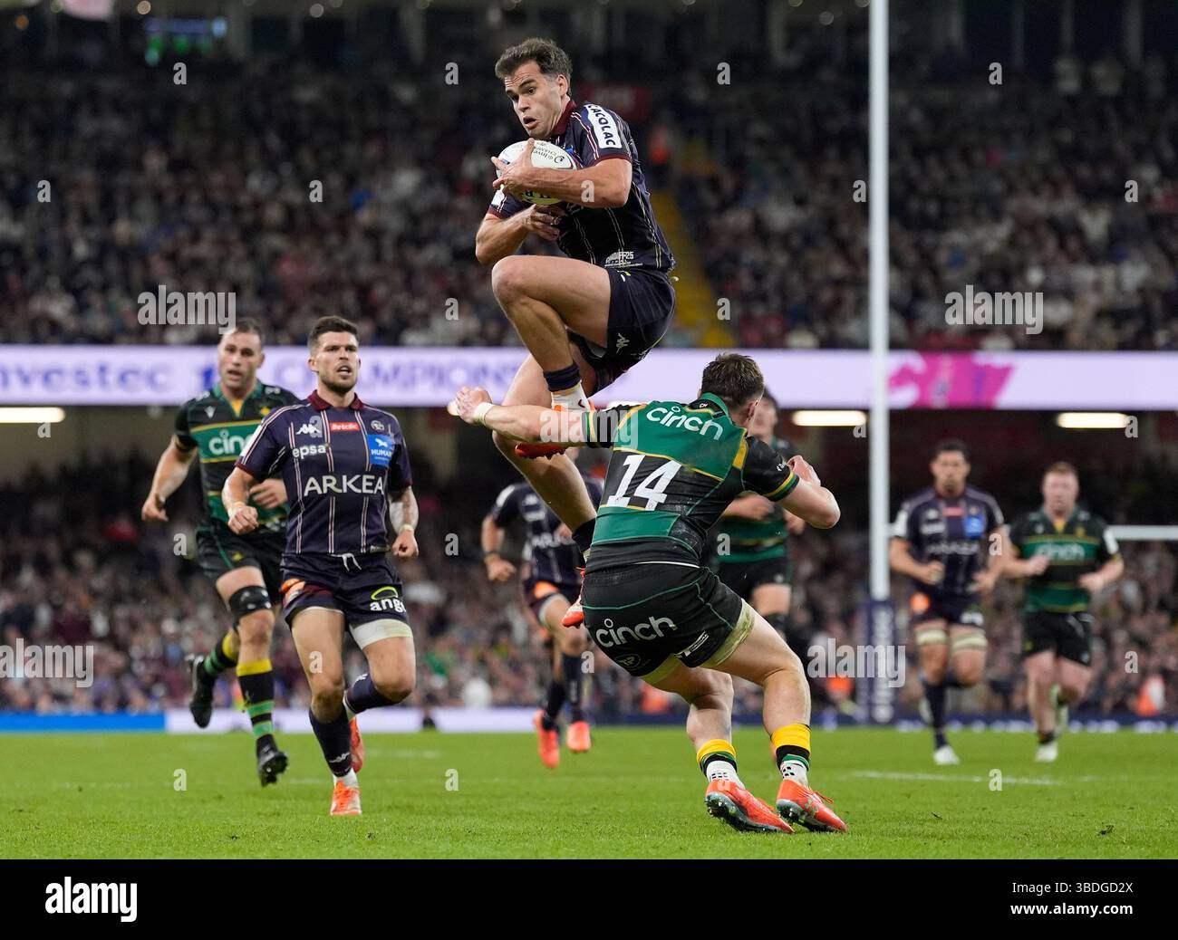 Northampton Saints' Tommy Freeman (right) tackles Union Bordeaux-Begles ...