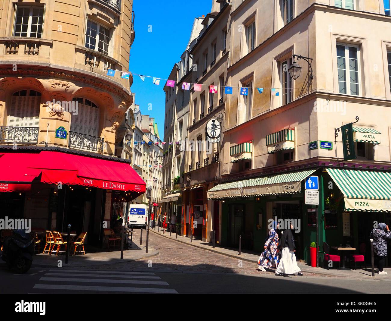 Summer street scene in Paris with Olympic decorations and café ...