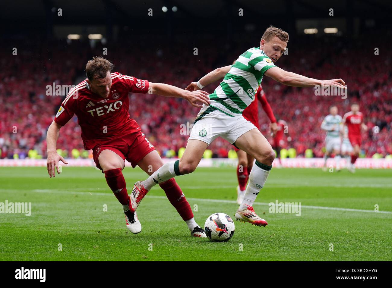 Aberdeen's Nicky Devlin (left) and Celtic's Alistair Johnston battle ...