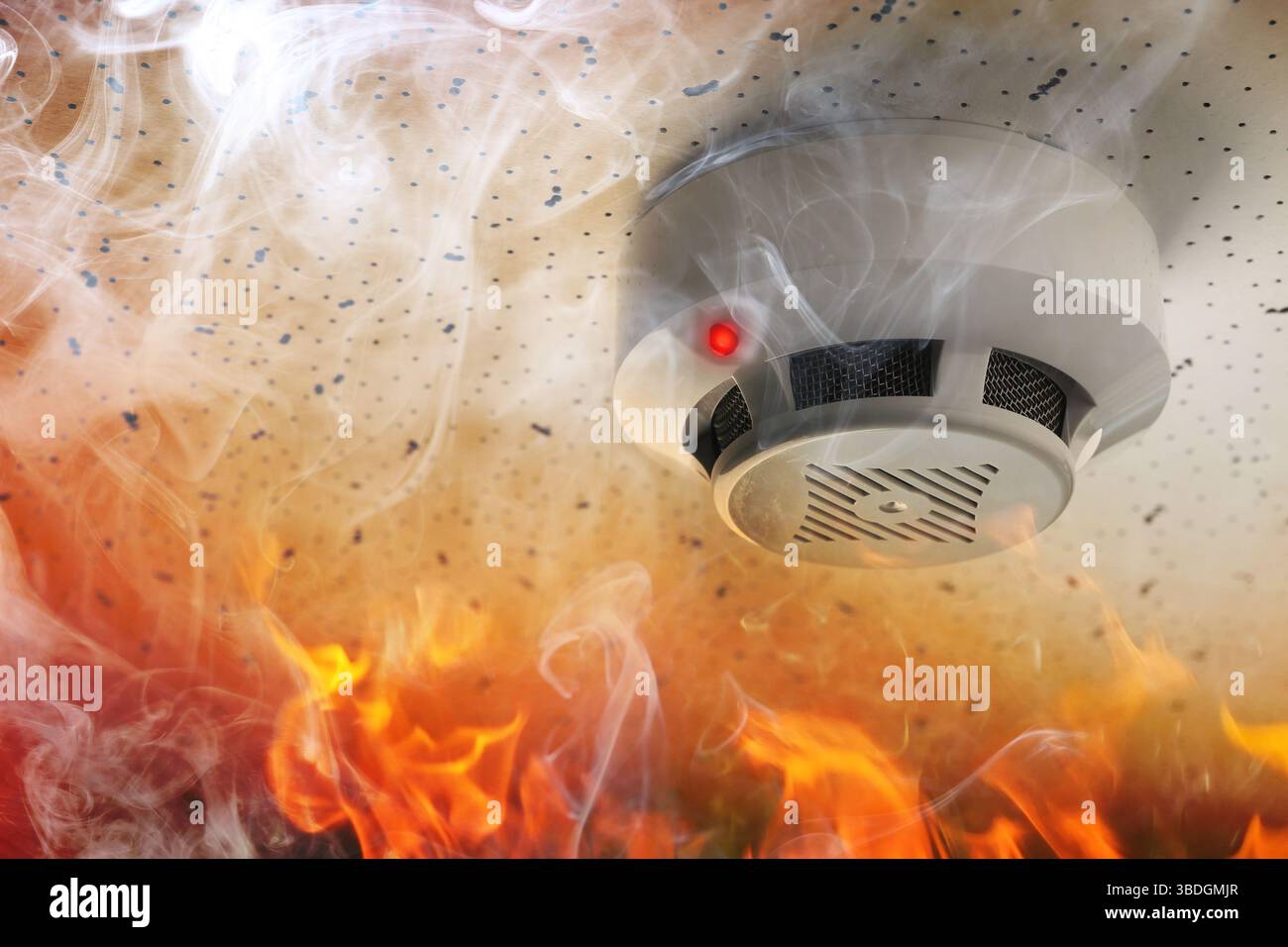 Fire alarm system. Detector on ceiling triggered by smoke and flame ...