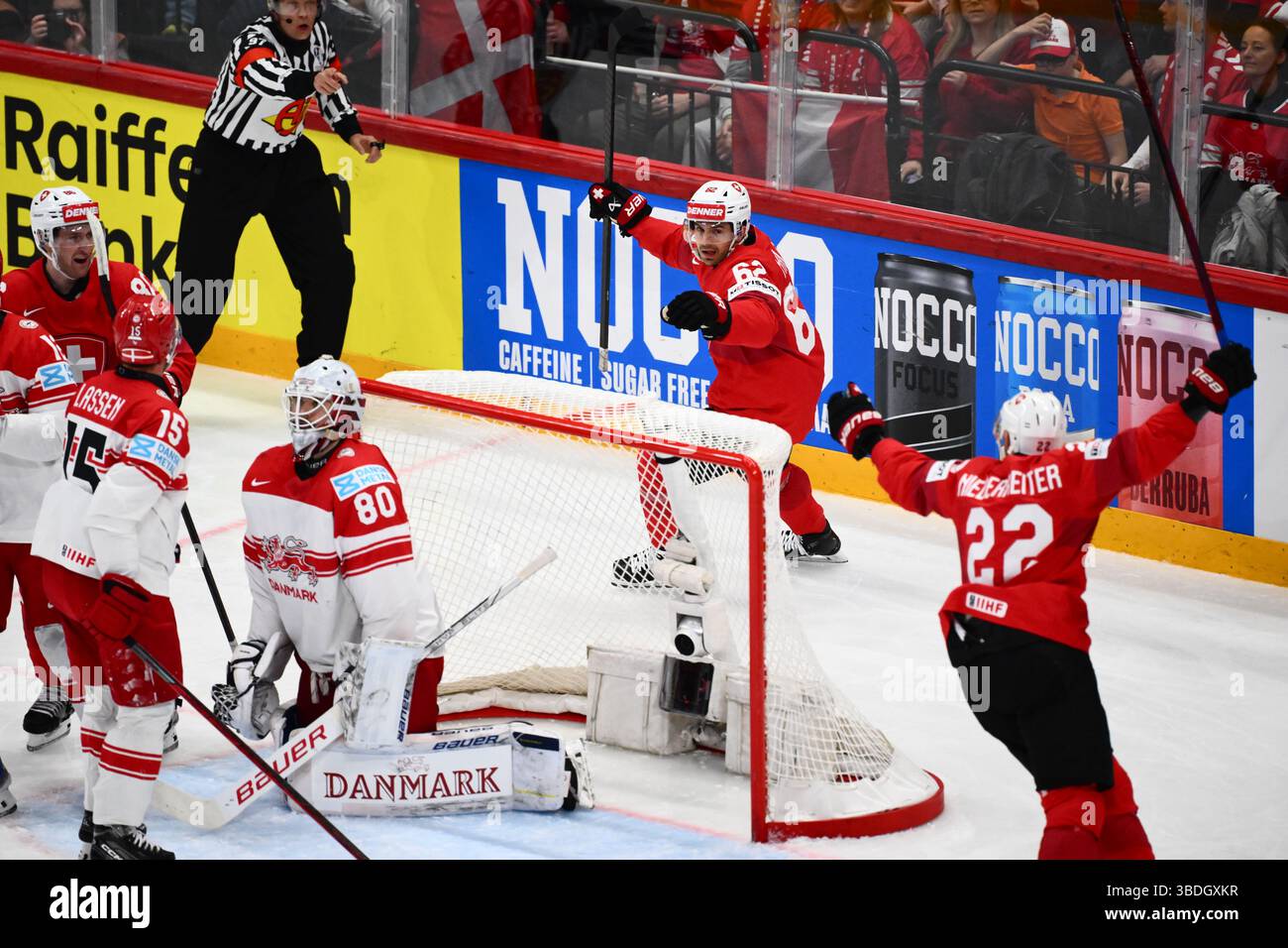 Stockholm, Sweden. 24th May, 2025. Nino Niederreiter of Switzerland (right) scores and ...
