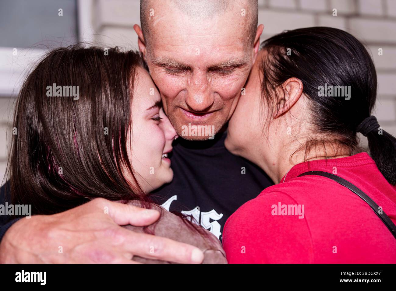 An Ukrainian soldier hugs with women after returning from captivity ...