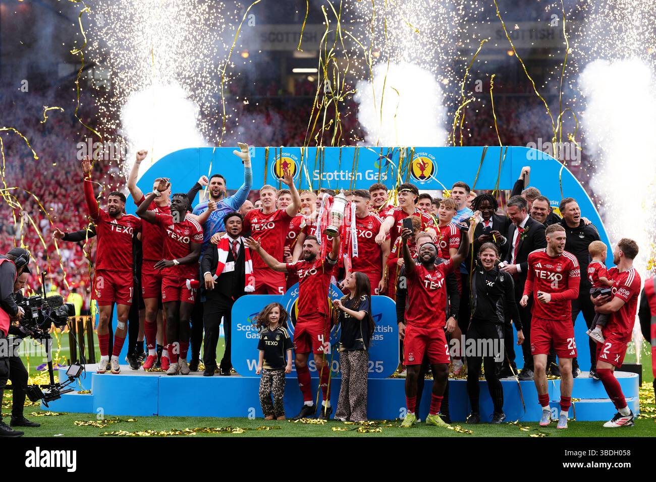 Aberdeen's Graeme Shinnie (centre) lifts the trophy after winning the ...