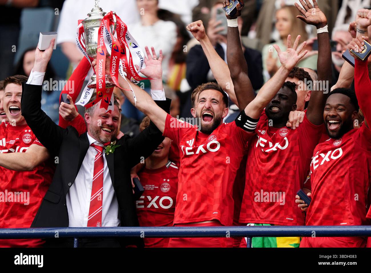 Aberdeen's Graeme Shinnie (centre) lifts the trophy after winning the ...